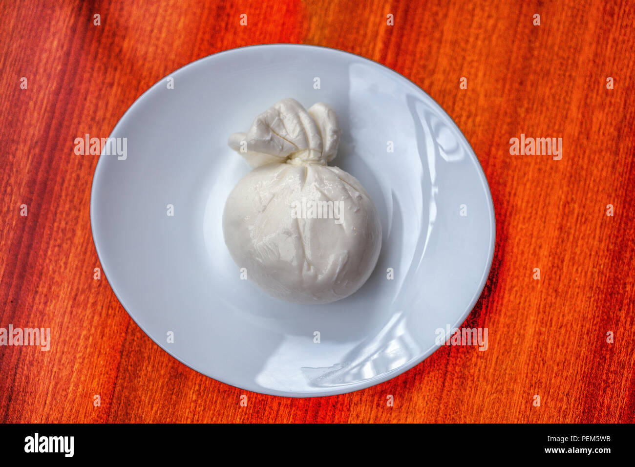 Burrata, typical Southern Italian soft cheese filled with butter, in a ...