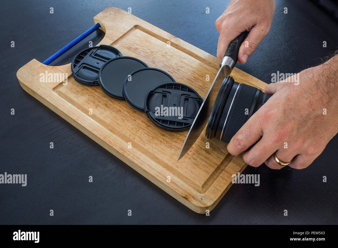 Chopping board with hand wich looks like cutting camera lens creating ...