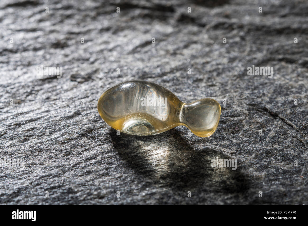 Gel capsule on a stone background Stock Photo - Alamy