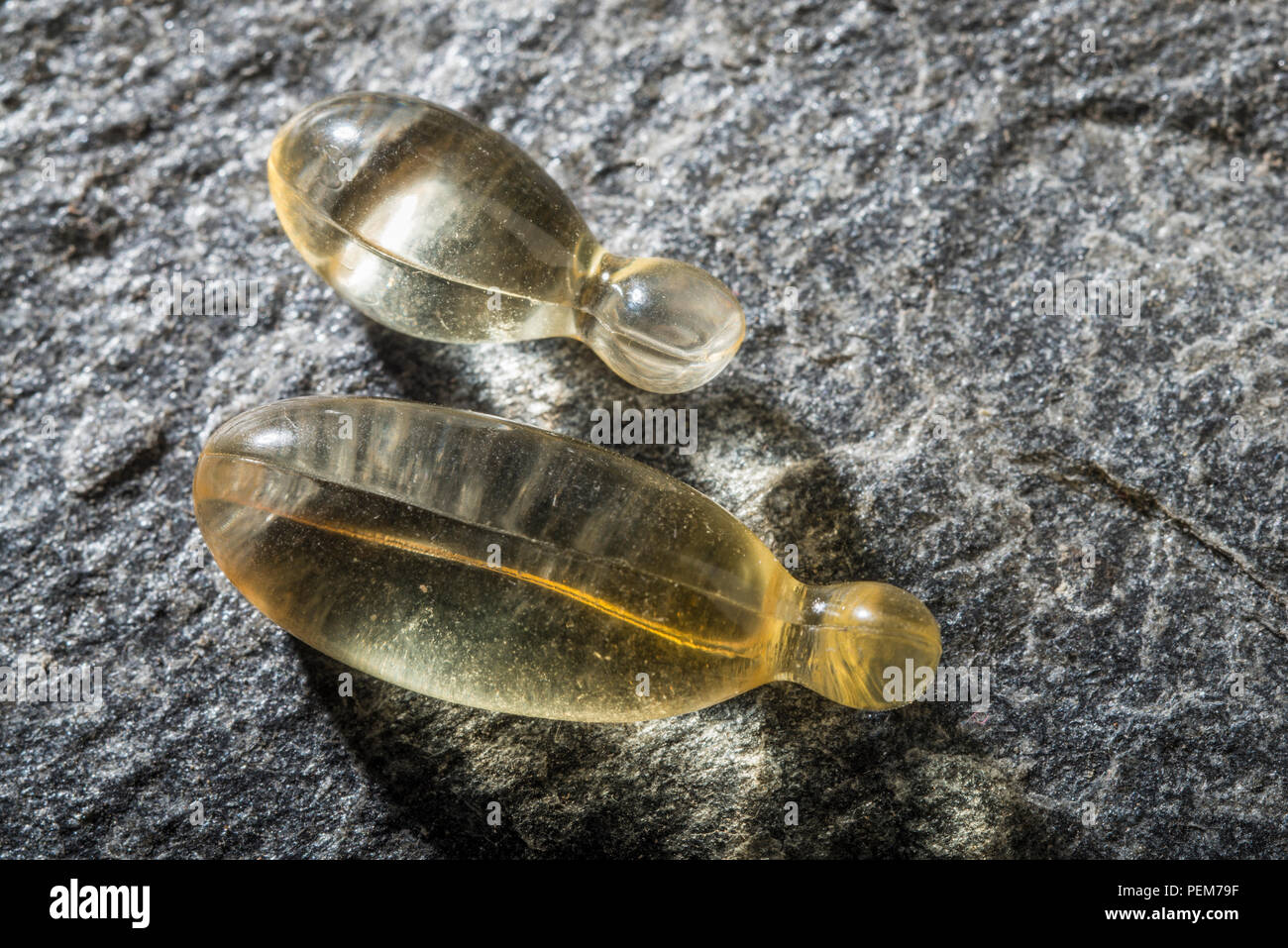 Gel capsules on a stone background Stock Photo - Alamy