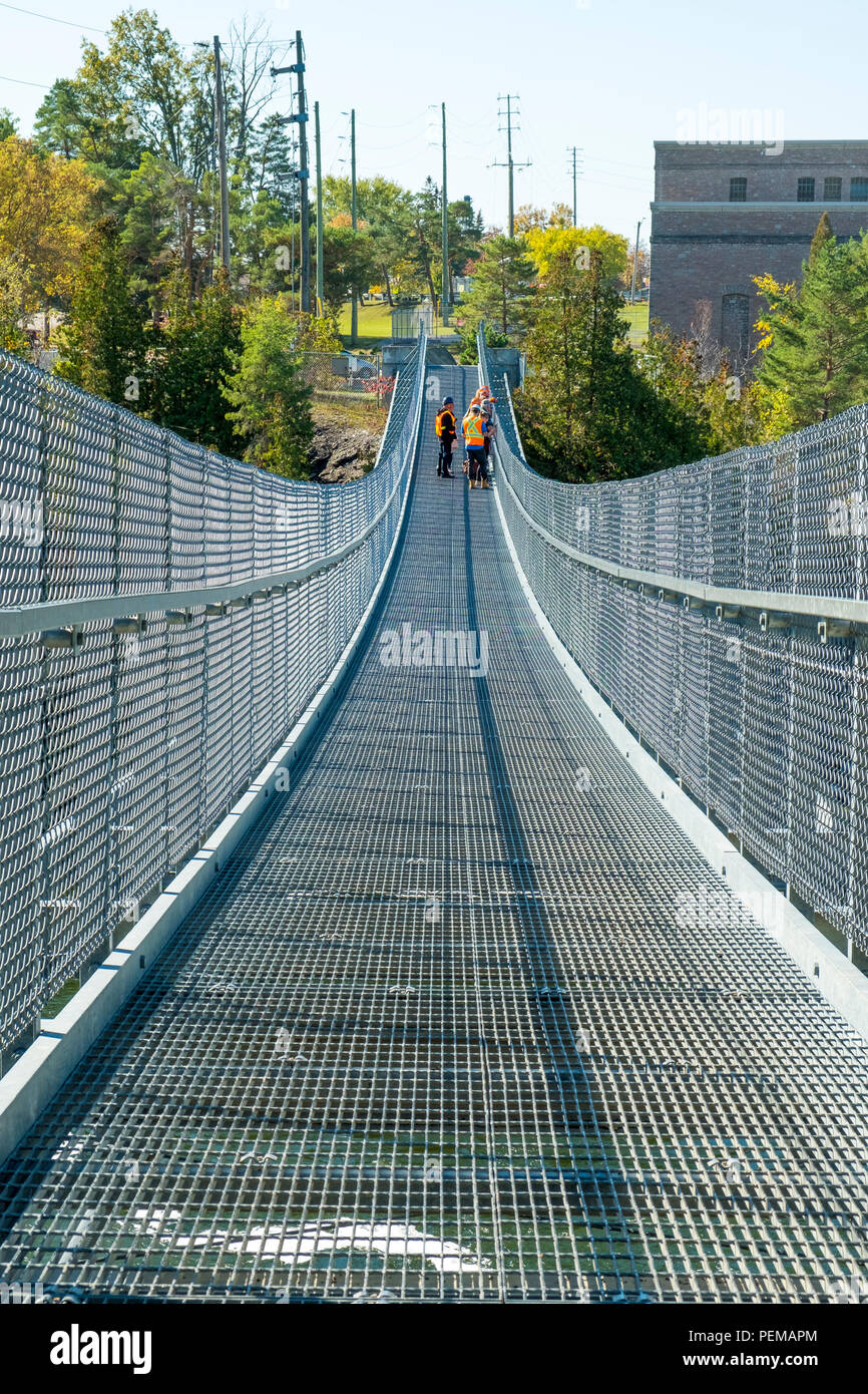 People in orange vests and white helmets stand on the Ranney Gorge ...