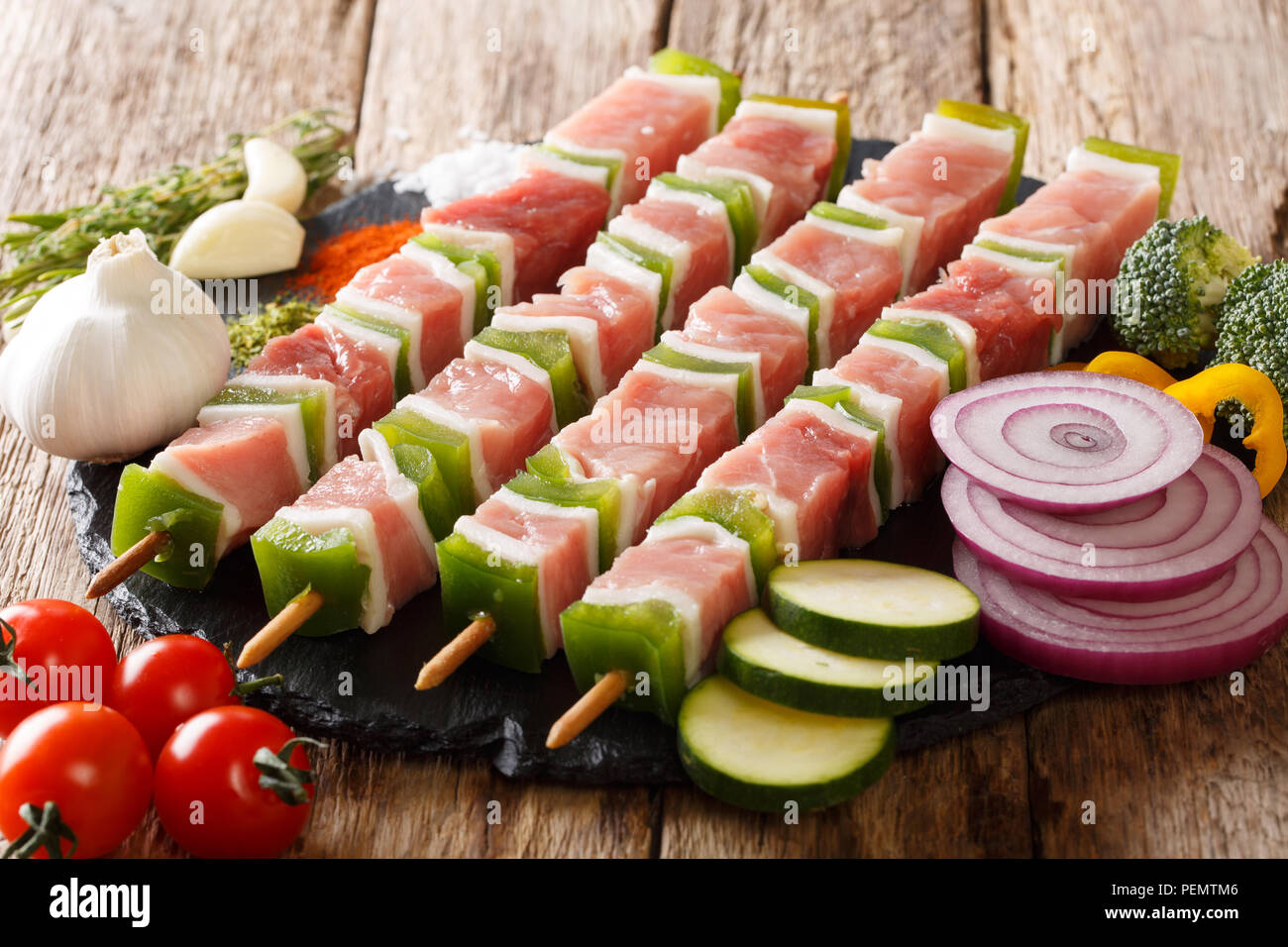 For barbecue raw shish kebab with pepper and lard on skewers close-up ...