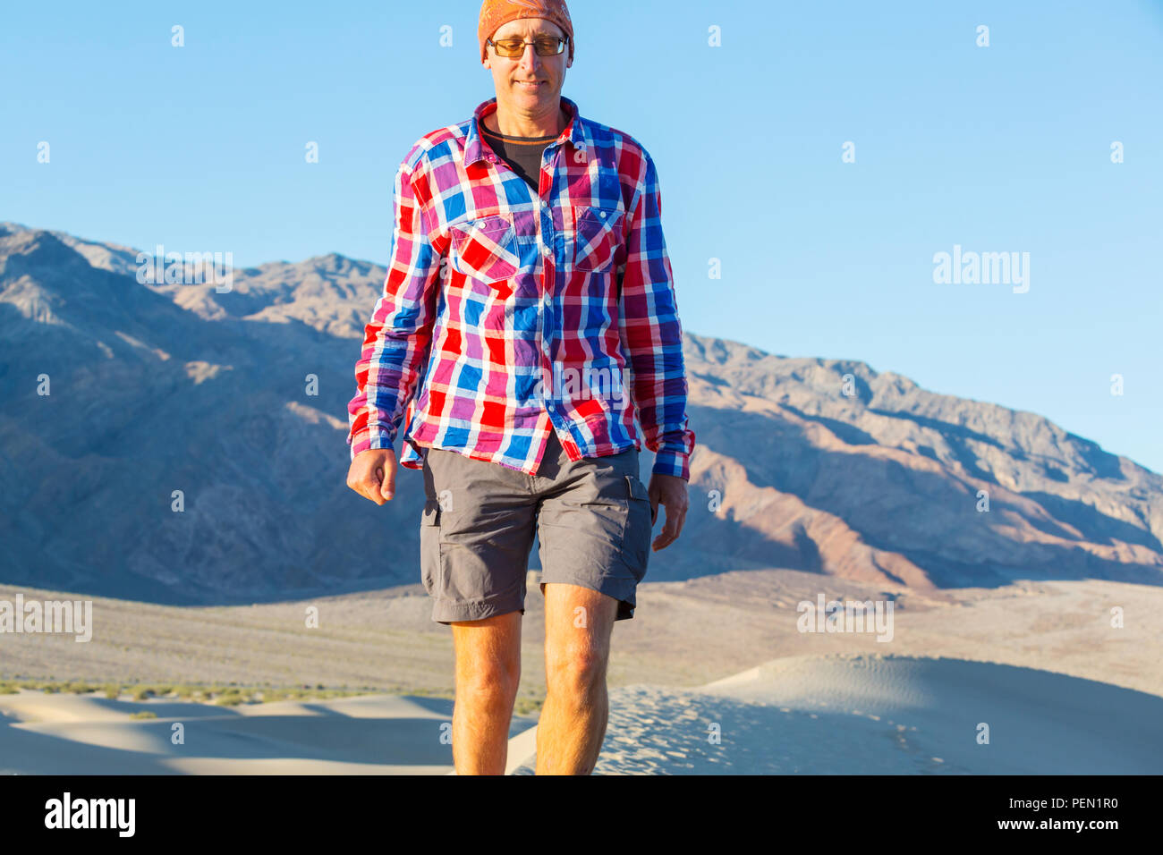 Man in sand desert Stock Photo - Alamy