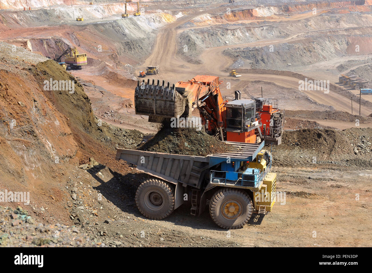 Loading of iron ore on very big dump-body truck Stock Photo - Alamy