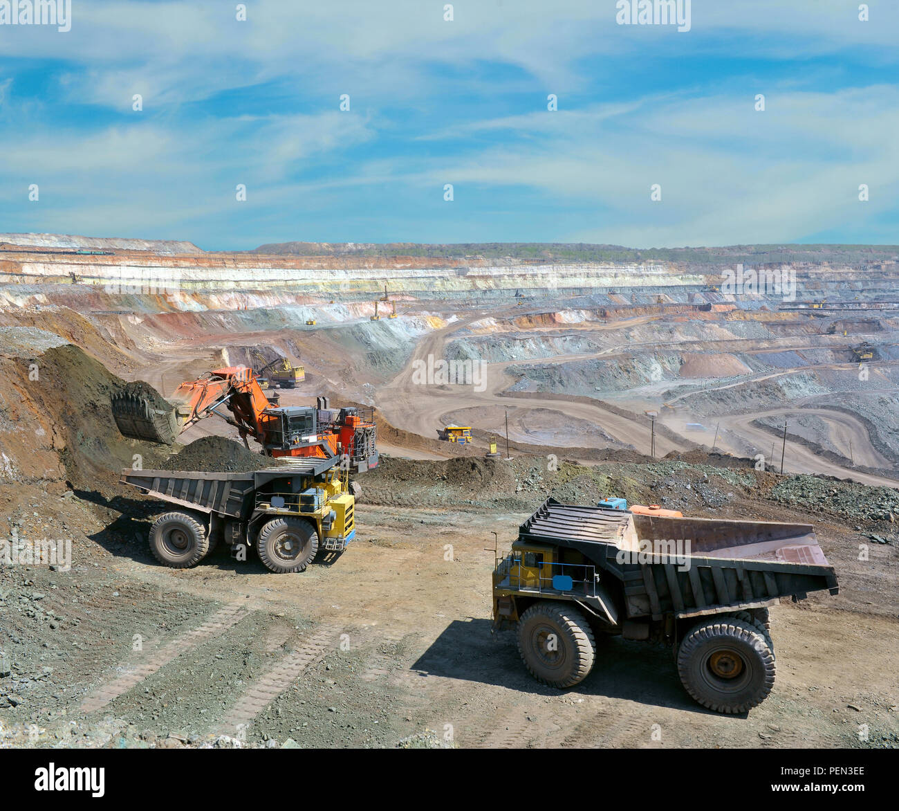 Loading of iron ore on very big dump-body truck Stock Photo - Alamy