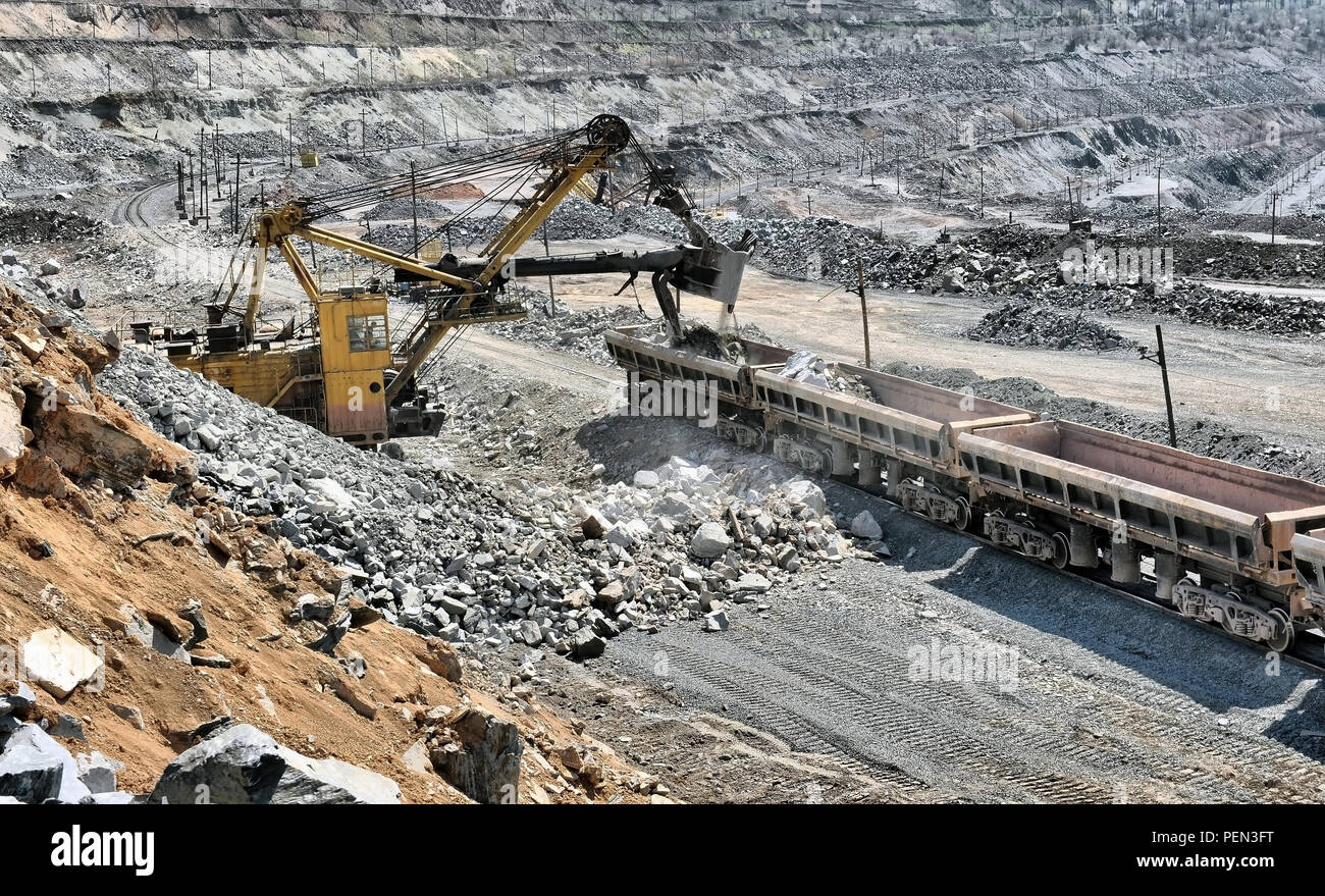 Loading of iron ore on the train in career Stock Photo - Alamy