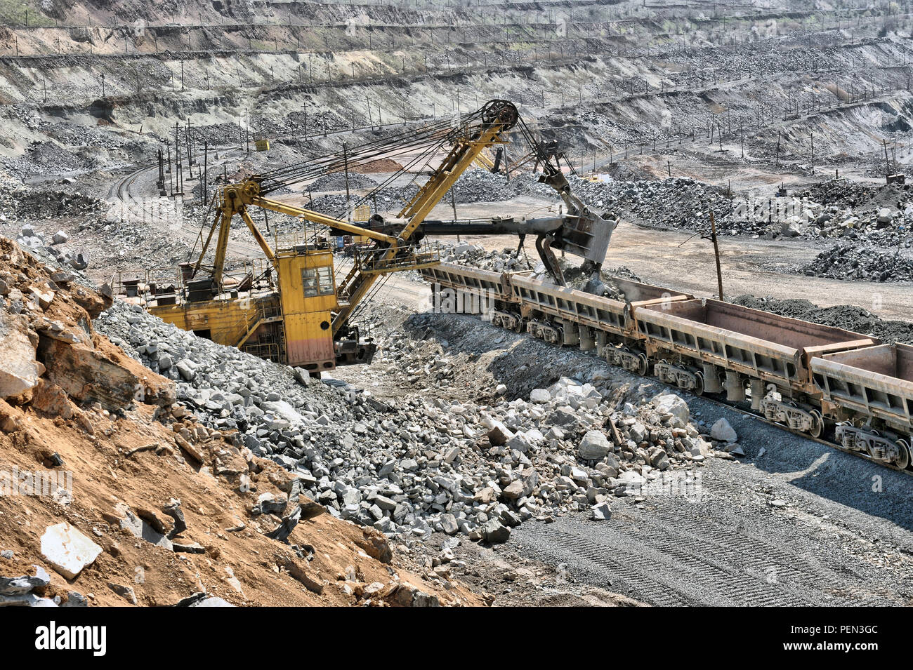 Loading of iron ore on the train in career Stock Photo - Alamy