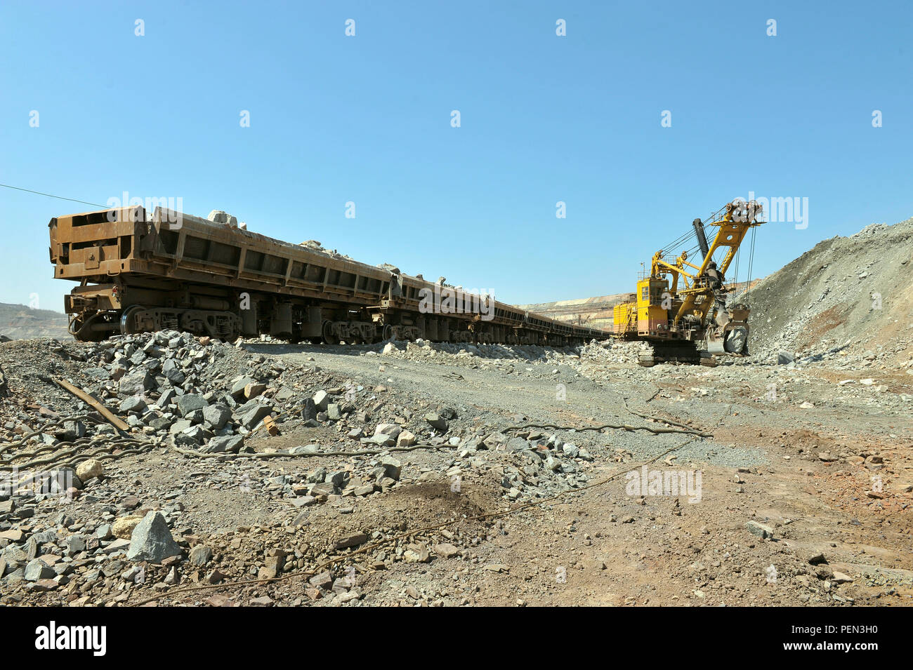 Loading of iron ore on the train in career Stock Photo - Alamy