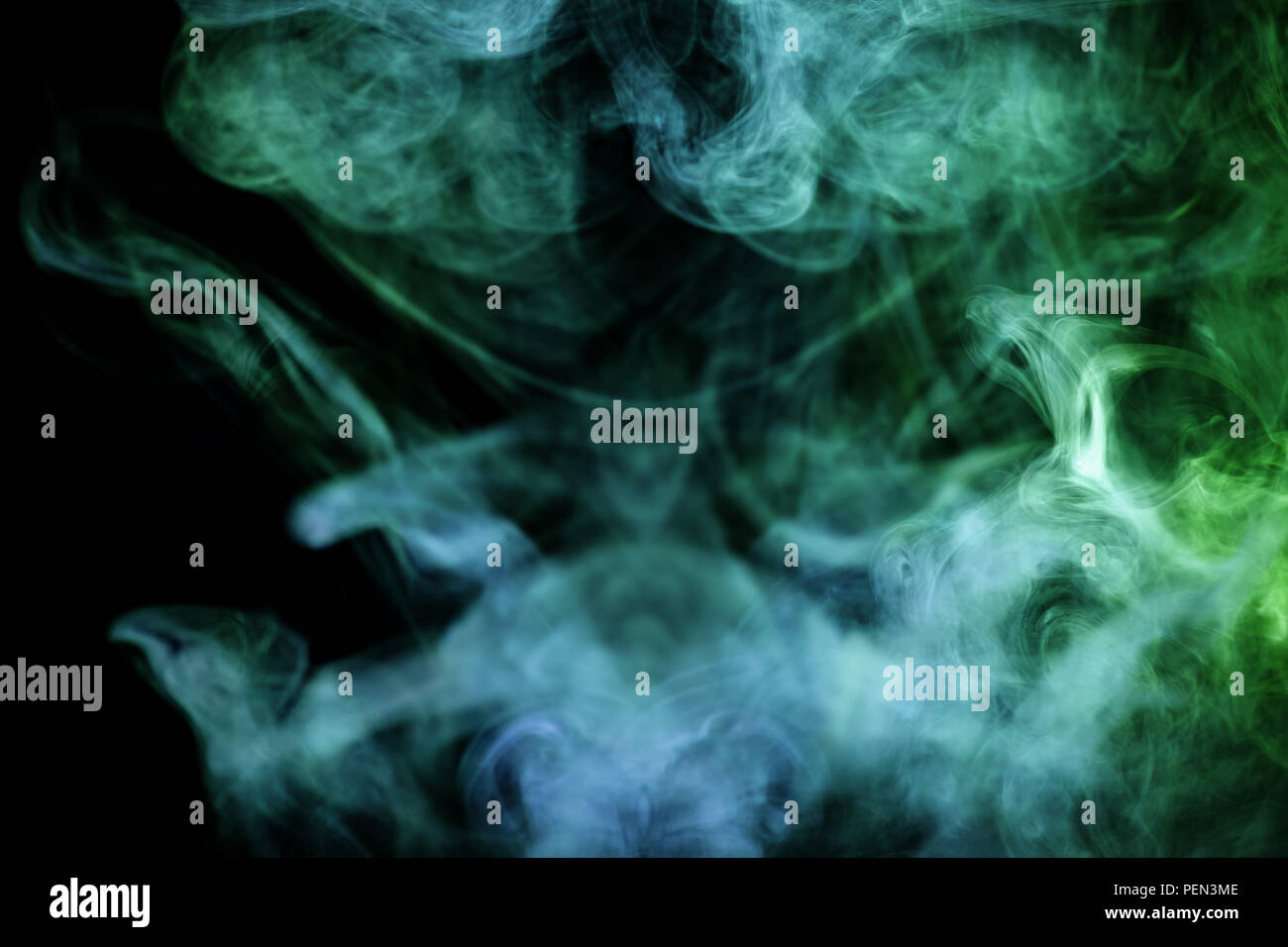 Thick green and blue smoke on a black isolated background. Background ...