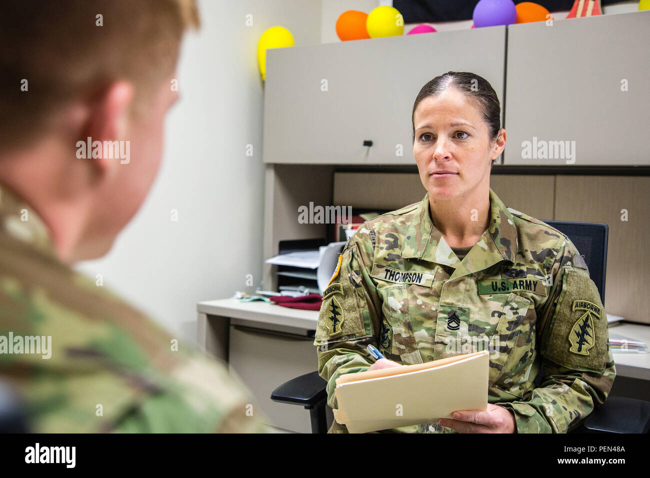 Sergeant First Class Jill Thompson, right, speaks with a soldier in her ...