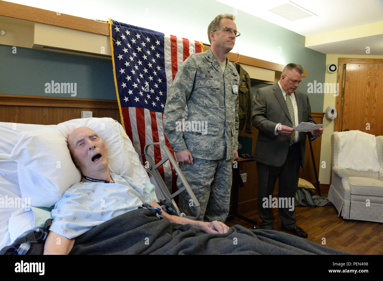 Col. Kent Olson, the 119th Wing commander, center, prepares to present ...