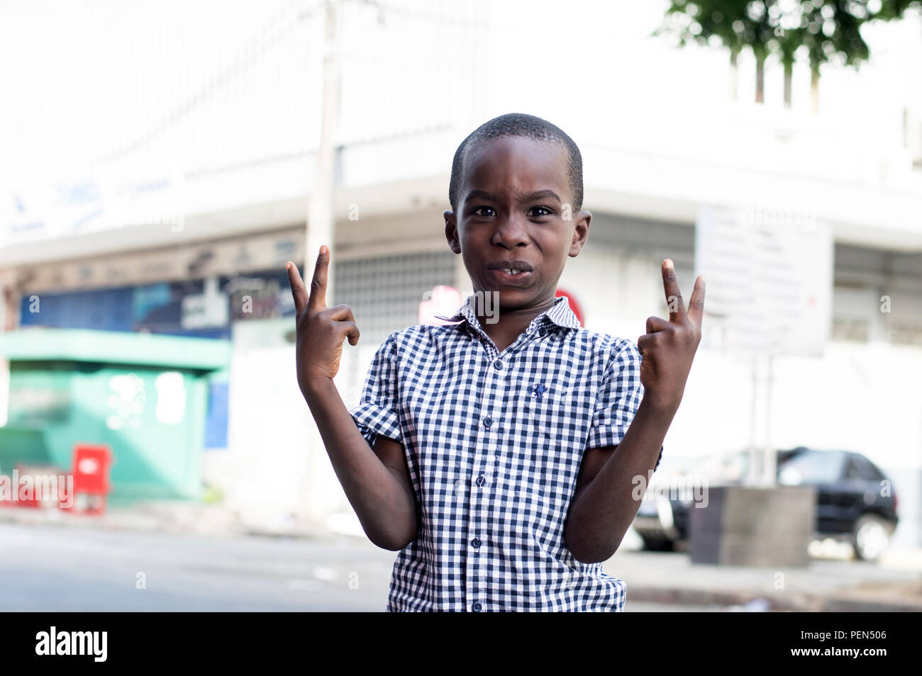 Happy little boy standing out by making signs of victory Stock Photo ...