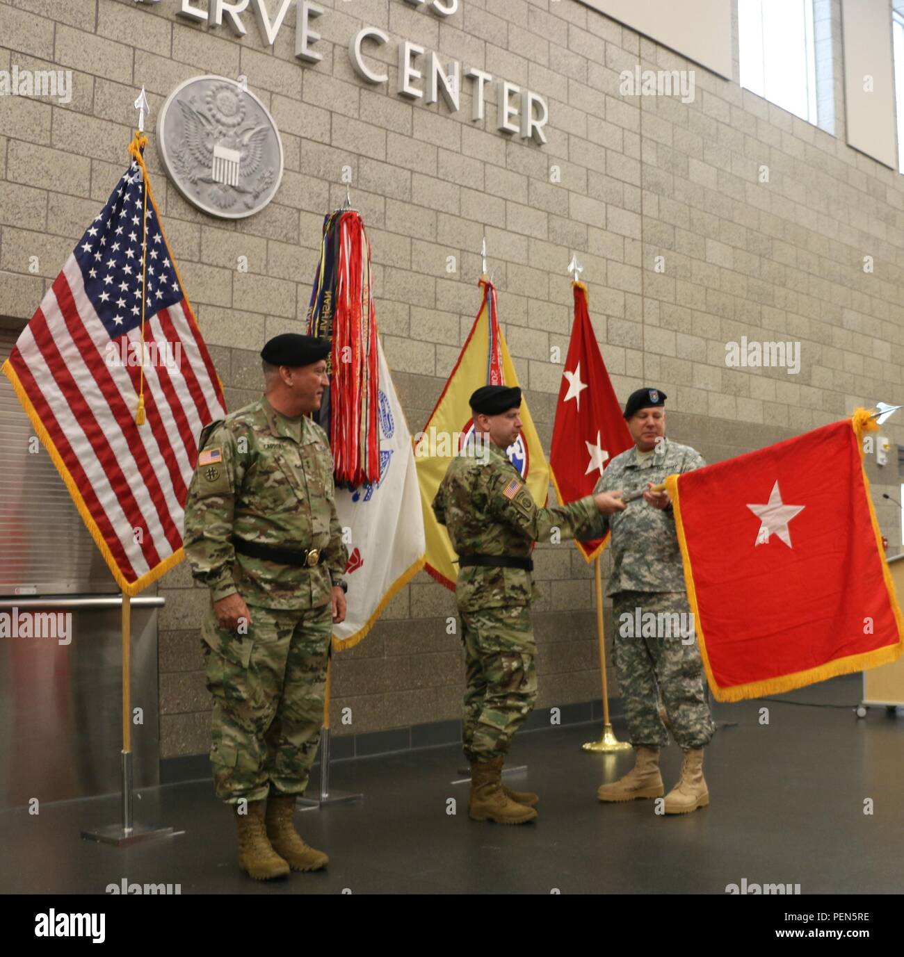 Brig. Gen. Vincent B. Barker (center) received the flag to symbolize ...