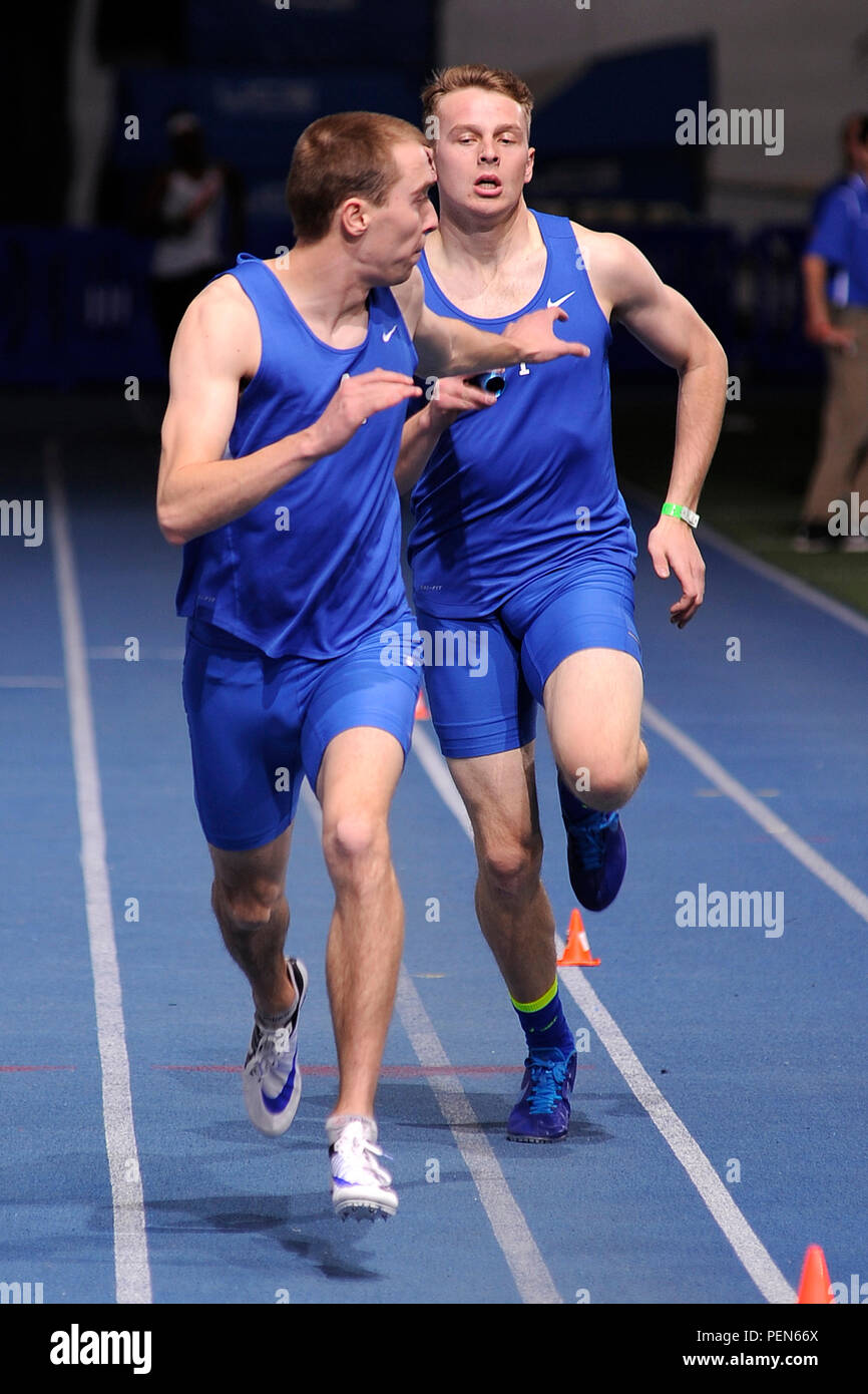 Garrett Newman, a junior, takes the baton from Chip White, a sophomore ...