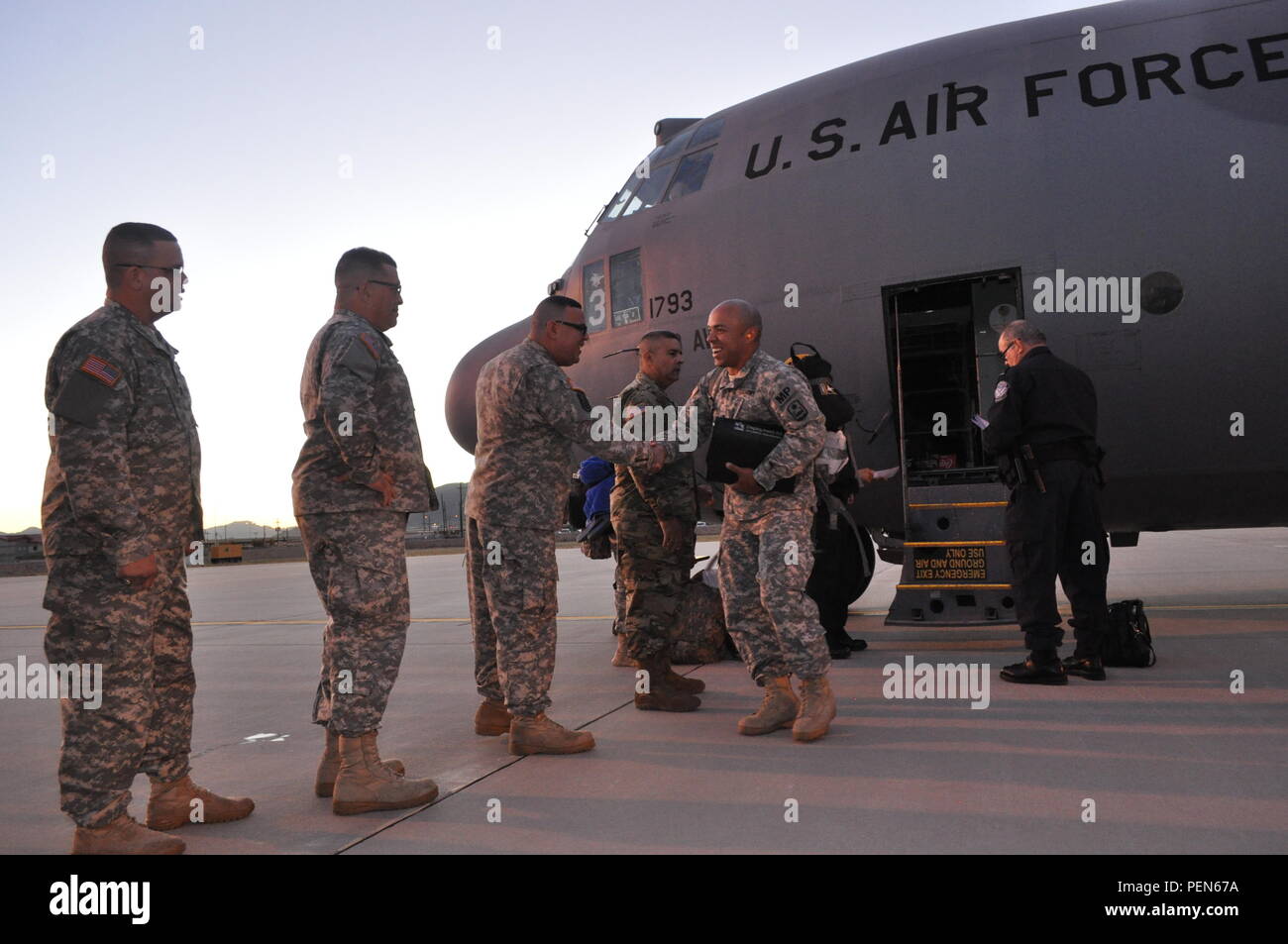 Maj. Jose Roman, center, commander, 124th MP Bn. greets a Soldier ...