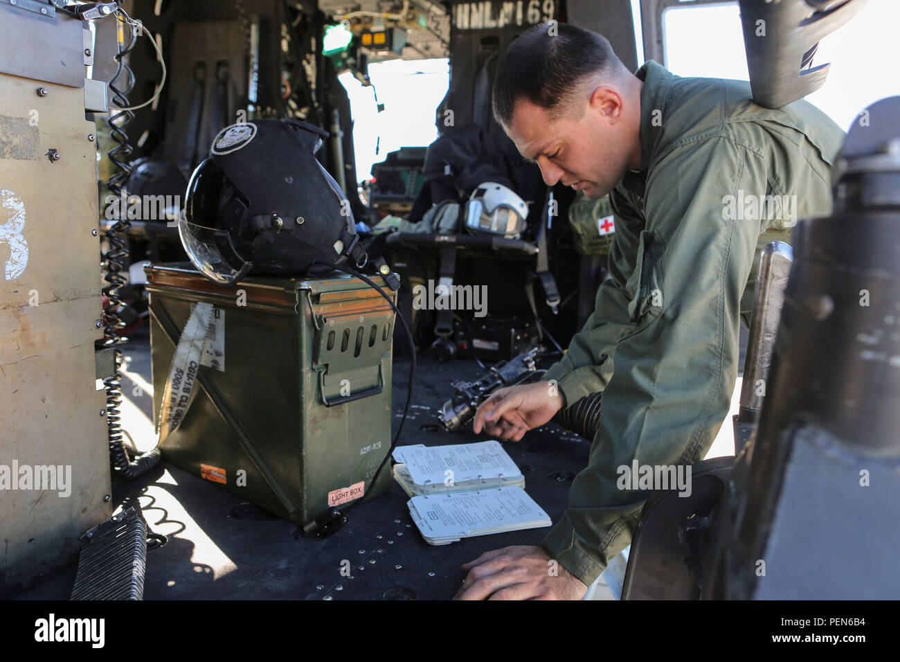 Lance Cpl. Taylor A. Vollmer studies a manual for the the M134 GAU-17 ...