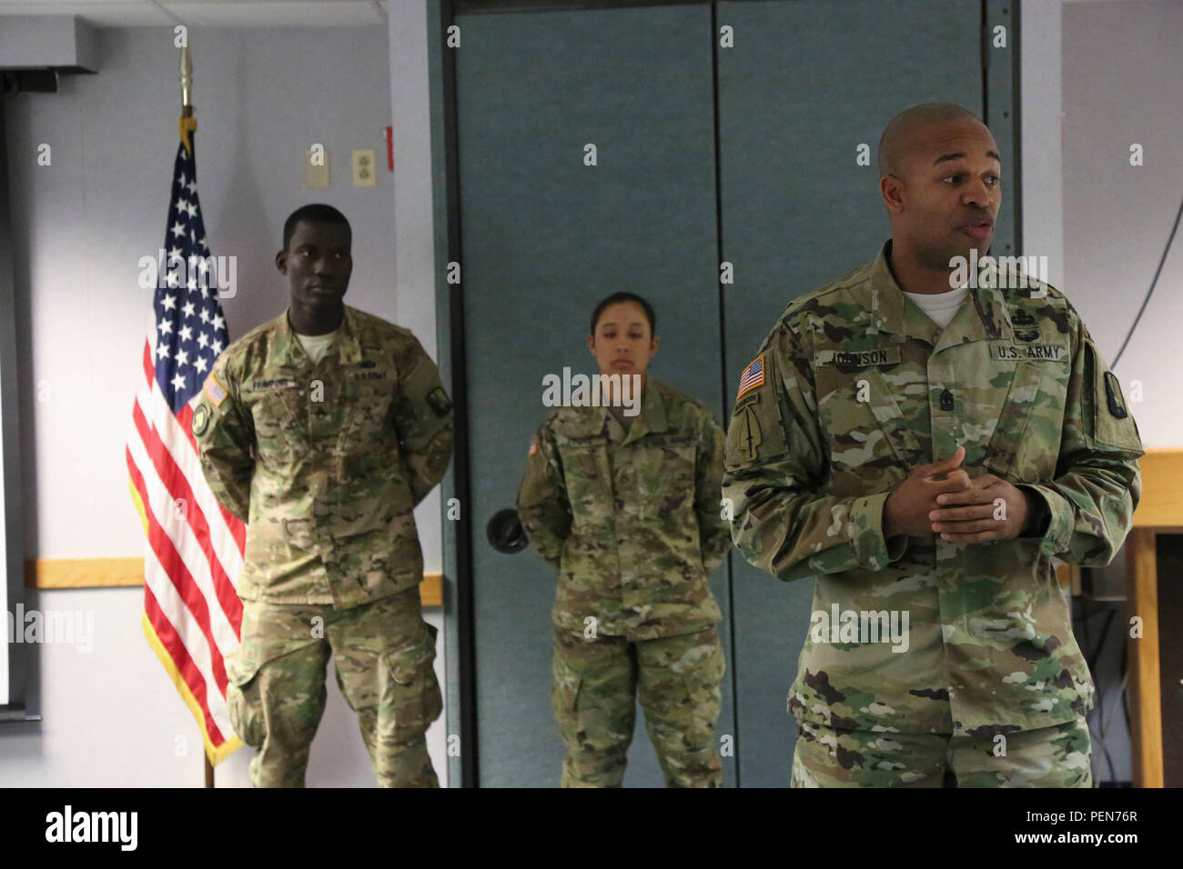U.S. Army 1st Sgt. Endesha Johnson, recognizes Staff Sgt. Kwadwo Frimpong and Pfc. Noel Toye ...