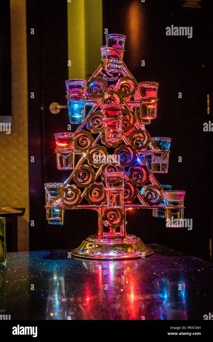 Cocktail Christmas tree illuminated in the dark Stock Photo - Alamy