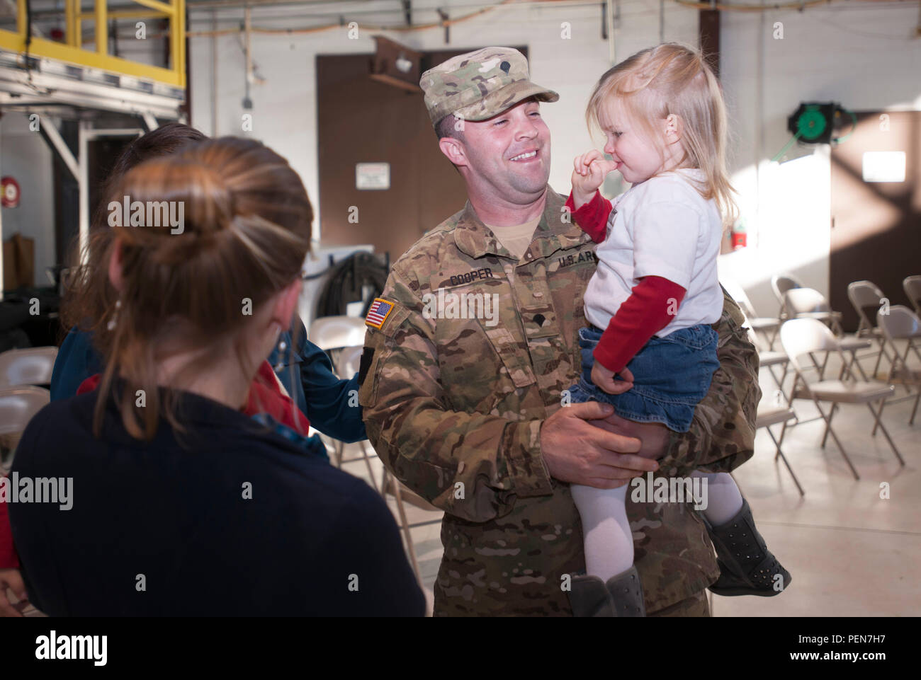 Spc. Joseph Cooper holds his daughter Gracie, 2, at a welcome home ...