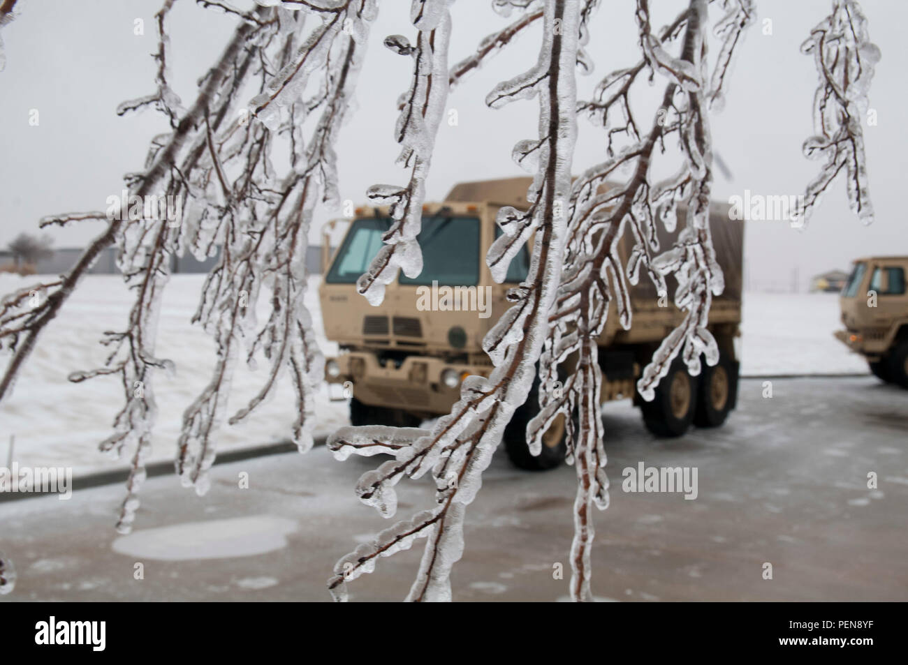 Ice covered trees, parking lots and the ground while light medium ...
