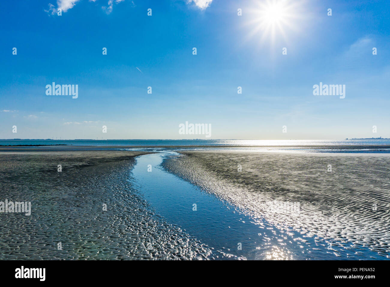 river split from ocean on the beach sunny day Stock Photo - Alamy