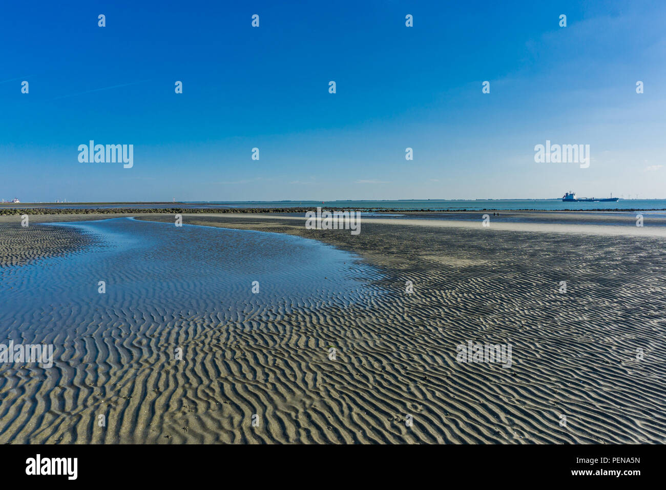 puddle split from the sea on a sandy beach Stock Photo - Alamy