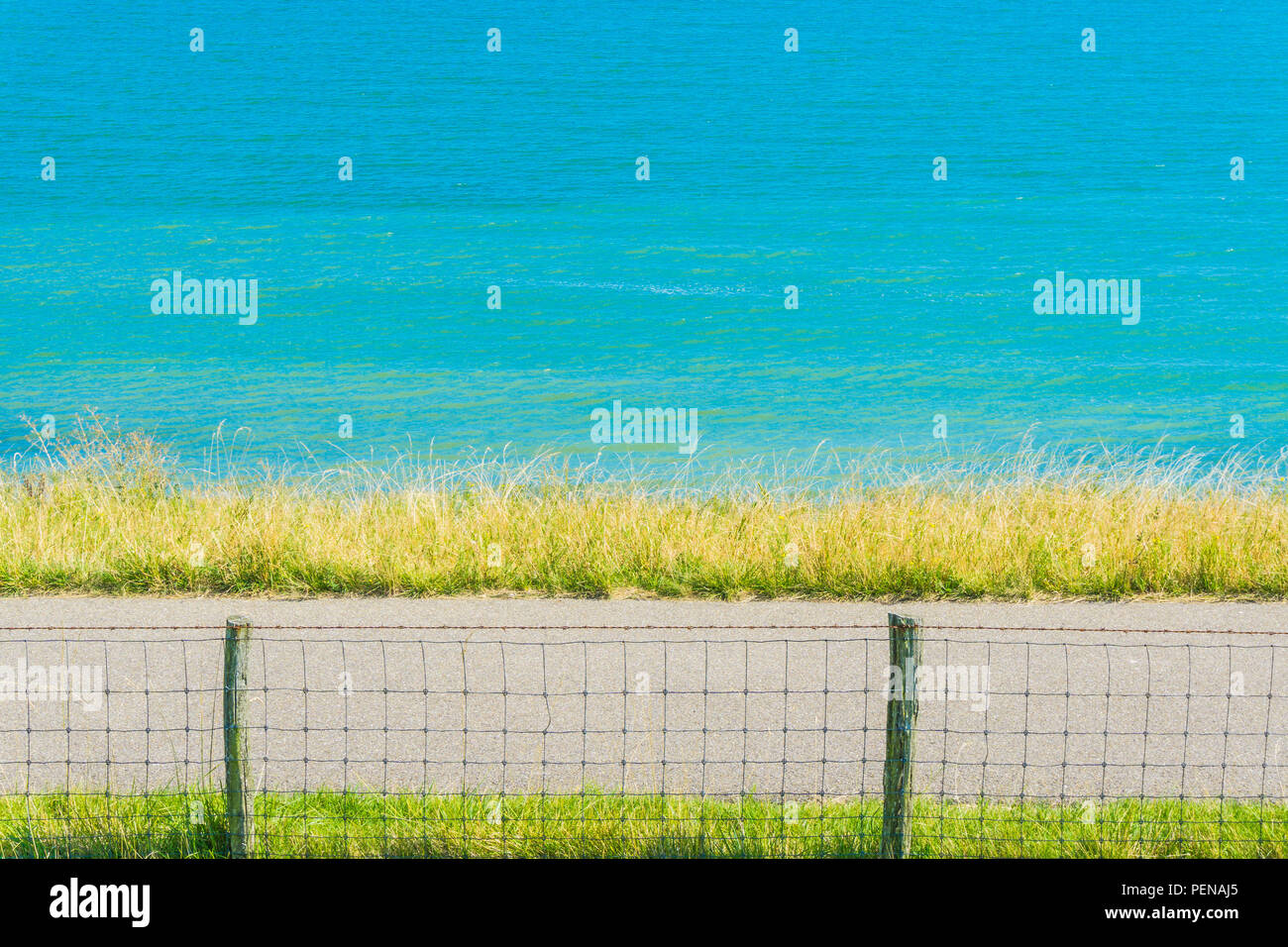 Water lake landscape with fence and road Stock Photo - Alamy