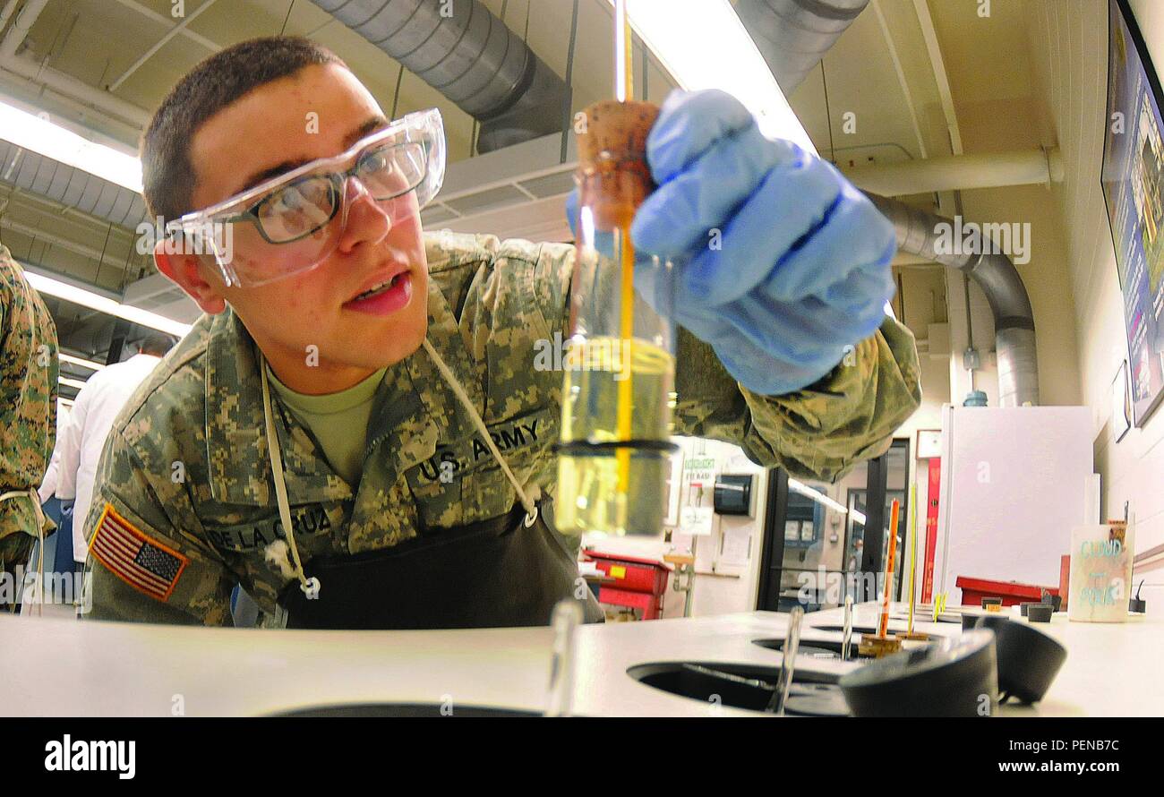 Pvt. Brandon De La Cruz examines a test sample during a recent ...