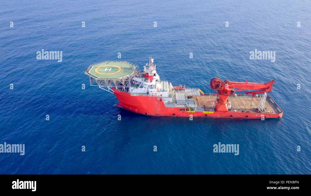 Aerial image of a Medium size red Offshore supply ship with a Helipad ...