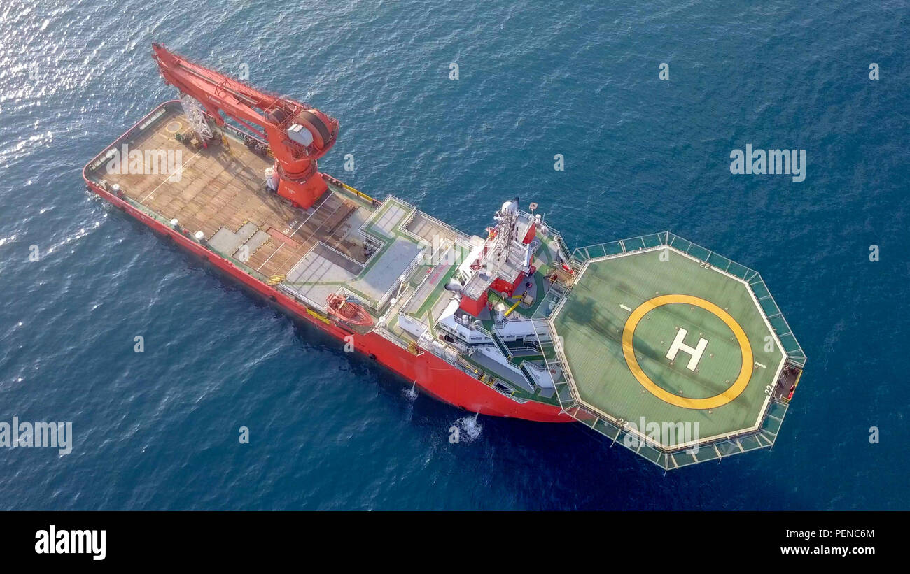 Aerial image of a Medium size red Offshore supply ship with a Helipad ...