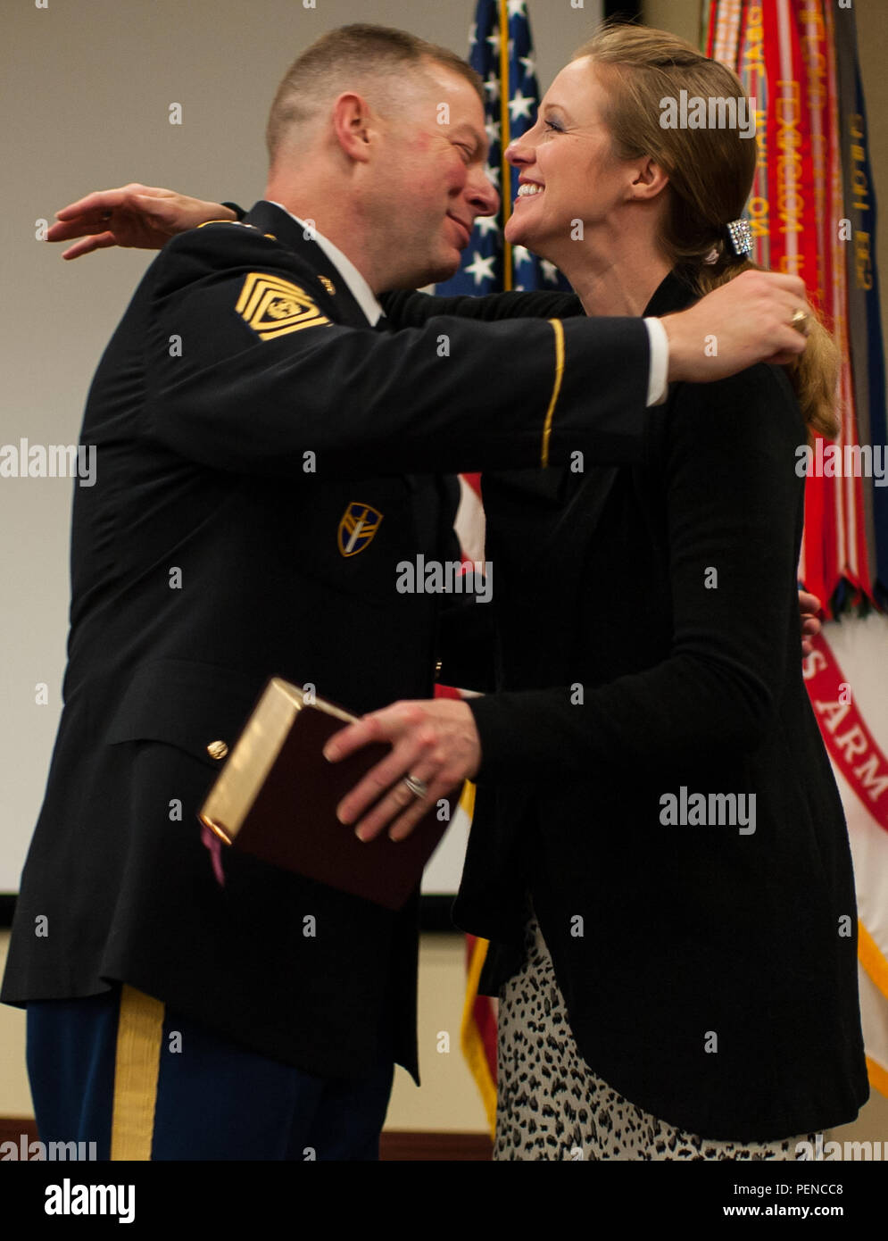 Command Sgt. Maj. James P. Wills is congratulated by his wife, Lisa ...