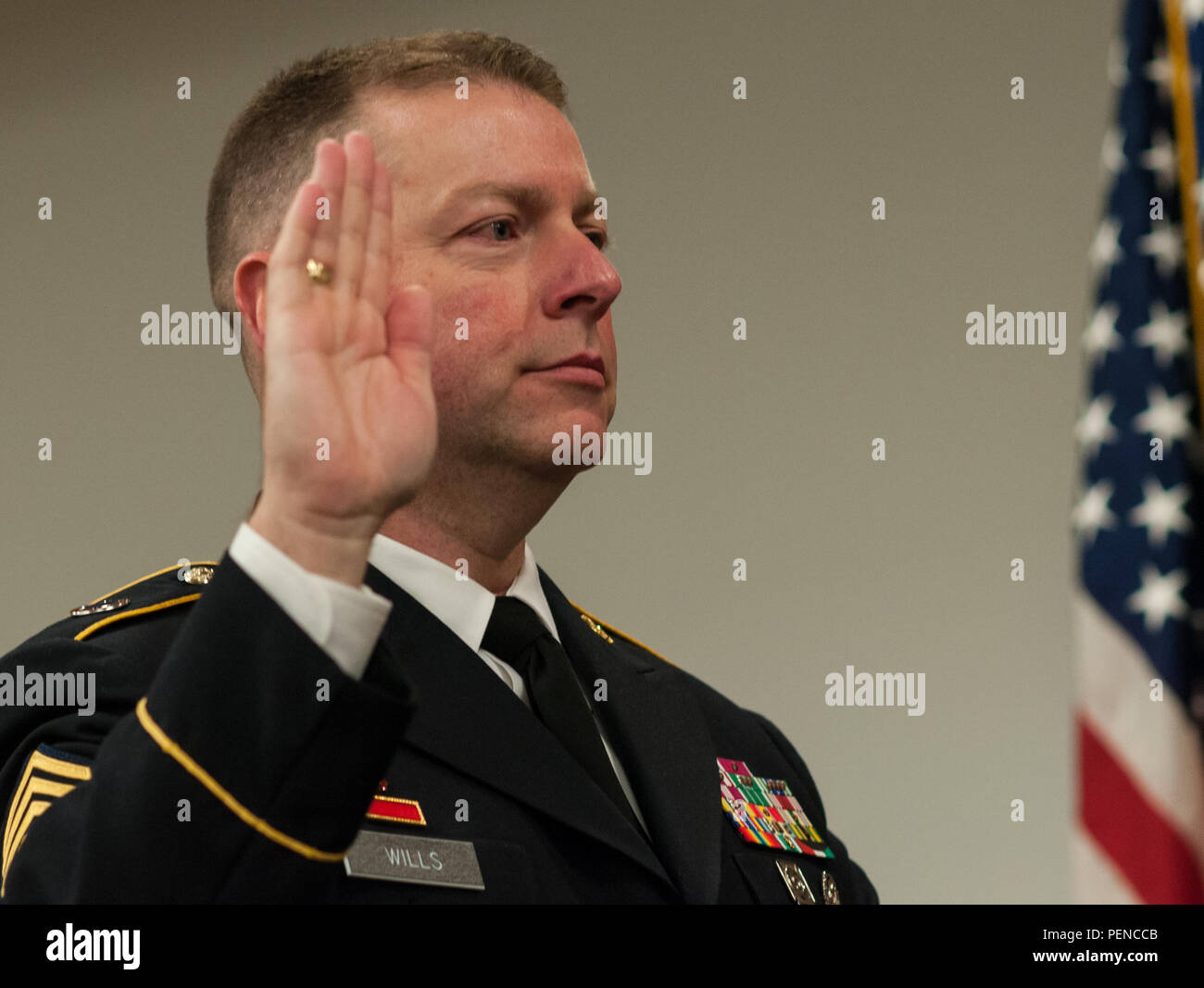 Command Sgt. Maj. James P. Wills takes the oath of office during a ...