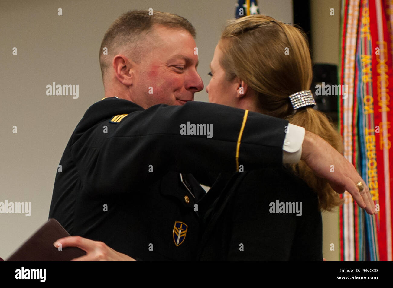 Command Sgt. Maj. James P. Wills is congratulated by his wife, Lisa ...
