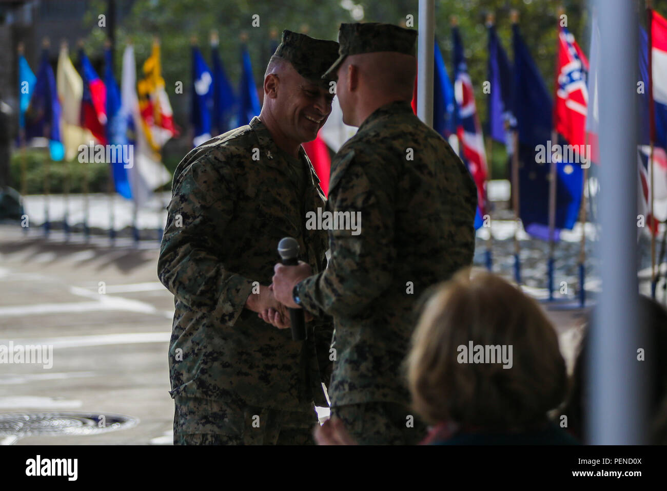 U.S. Marine Corps Col. Paul J. Nugent hands off the microphone to Lt ...