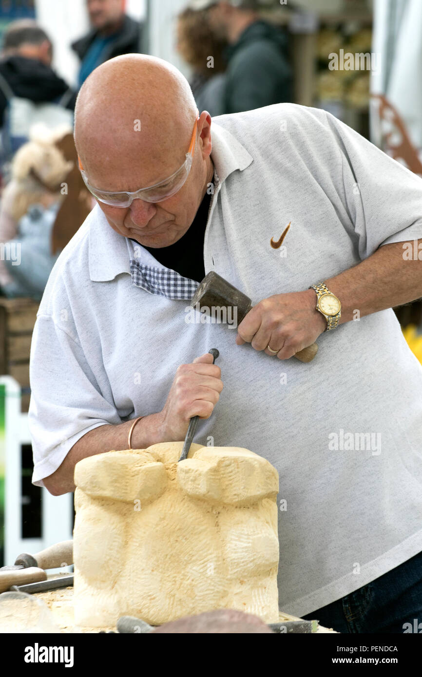 Handcarving sandstone with a chisel and hammer at Southport, UK Stock ...