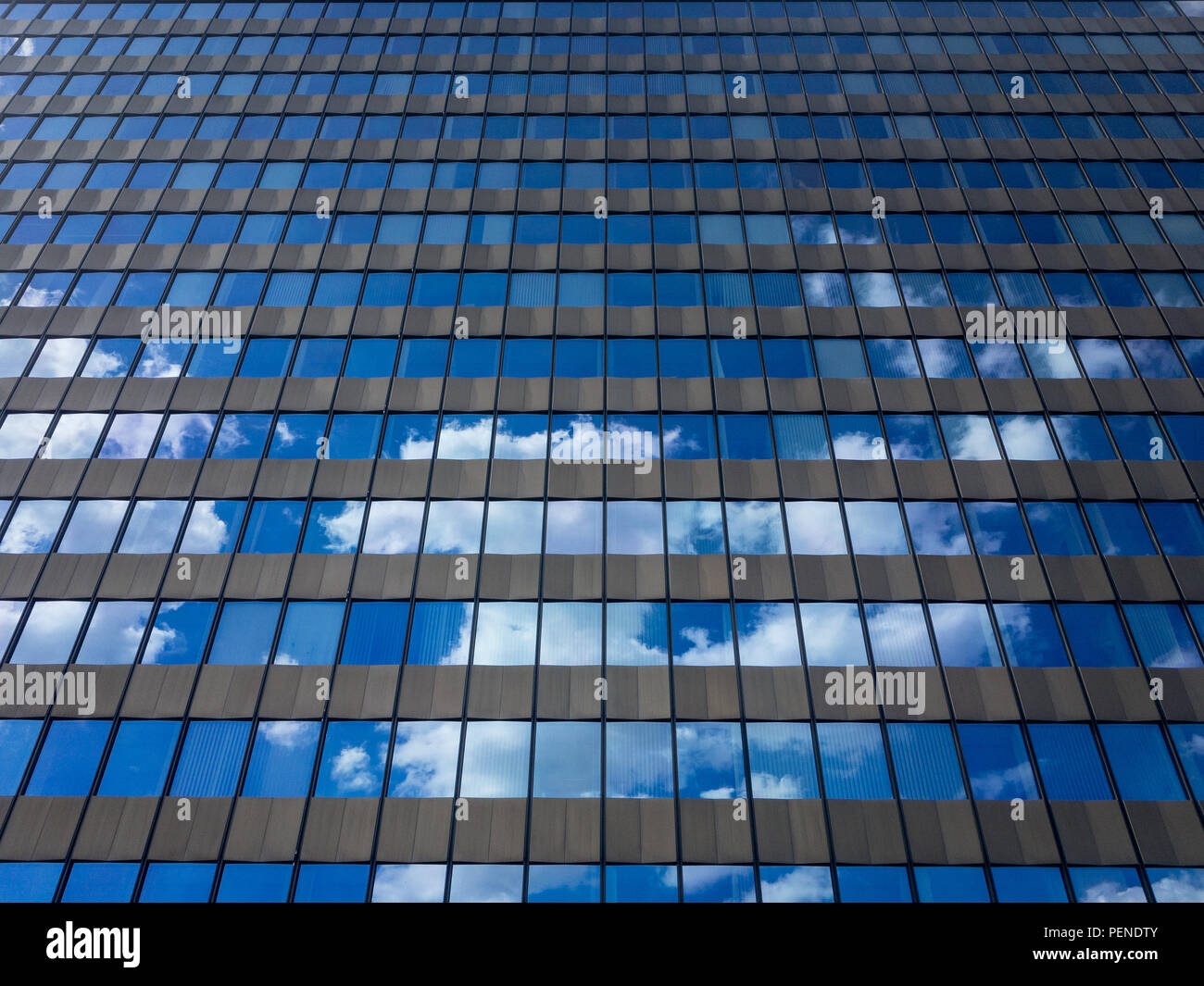 Office building windows with reflecting blue sky and clouds Stock Photo ...