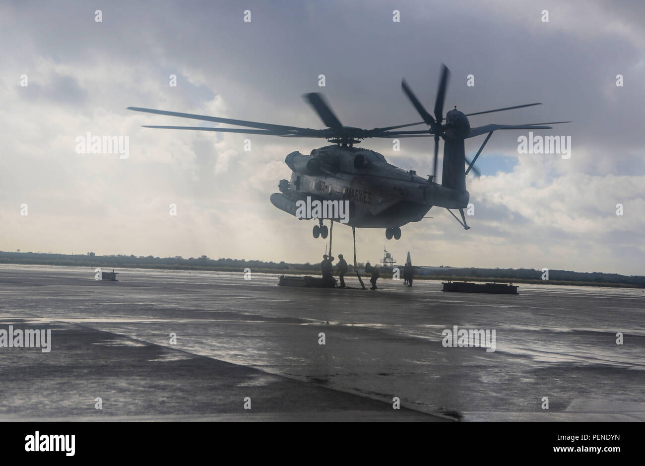 A CH-53E from Marine Heavy Helicopter Squadron (HMH) 465 hovers above ...