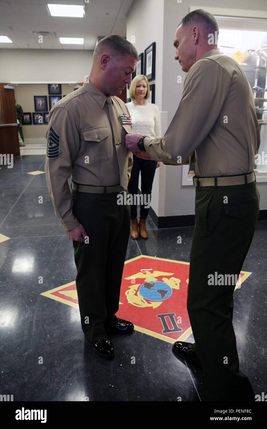 Maj. Gen. Gary L. Thomas (right) pins a Meritorious Service Medal on ...