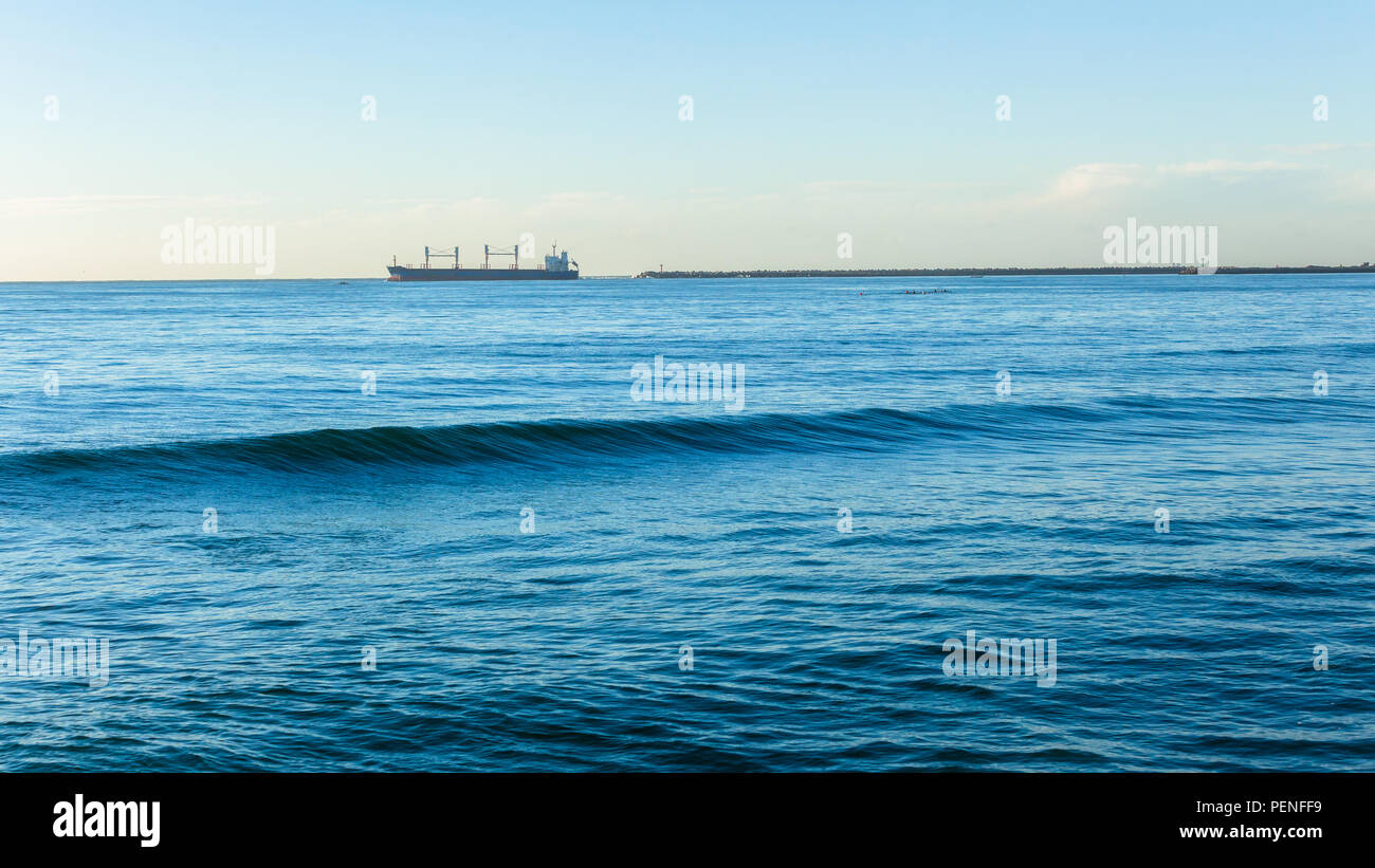 Ship departs harbor port piers onto ocean seas landscape Stock Photo ...
