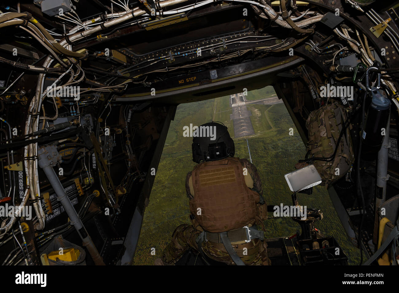 An aerial gunner looks out of the back of a CV-22 Osprey, Aug. 26, 2015 ...