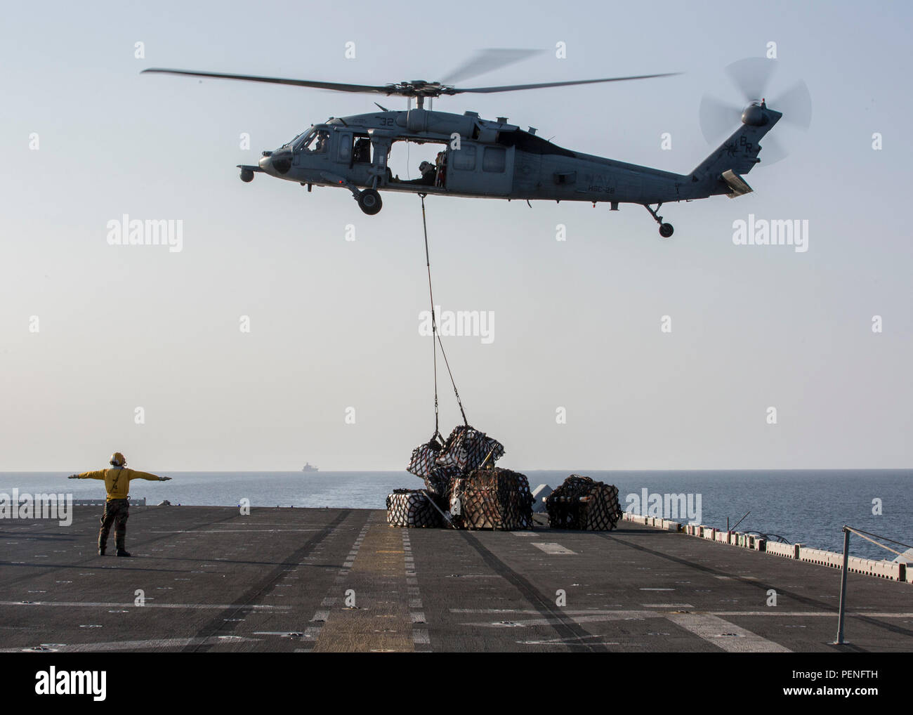 An SH-60 Seahawk with Amphibious Squadron (PHIBRON) 4 delivers packages ...