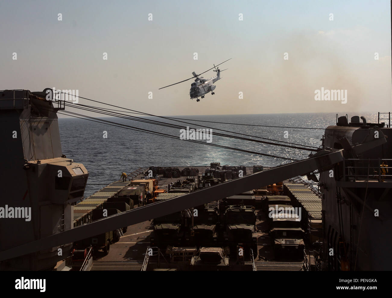 A U.S. Navy transport helicopter delivers pallets of cargo to the USS ...