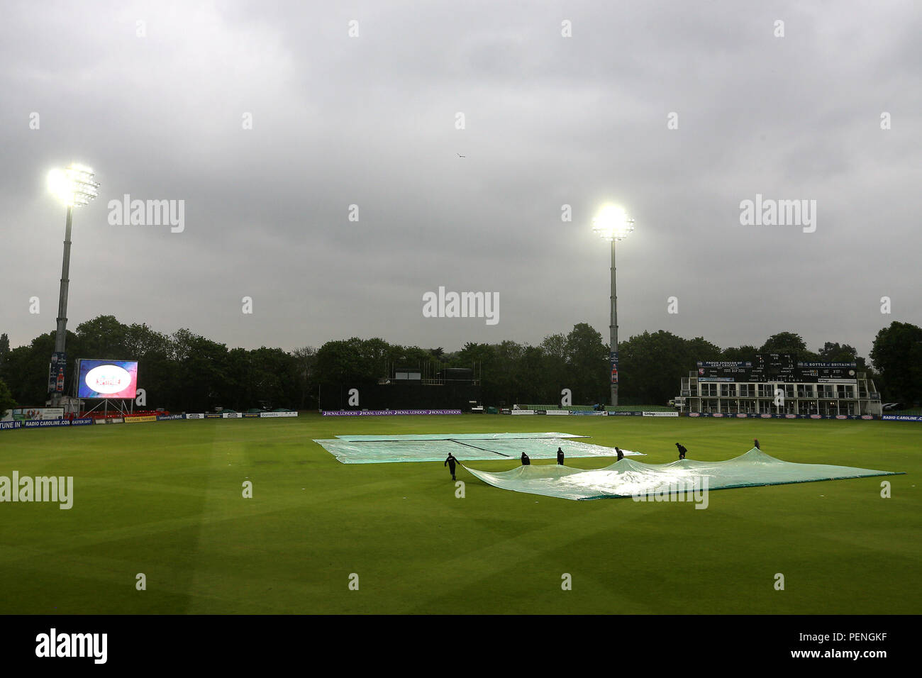 The covers come on as heavy rain stops plays during Kent Spitfires vs ...
