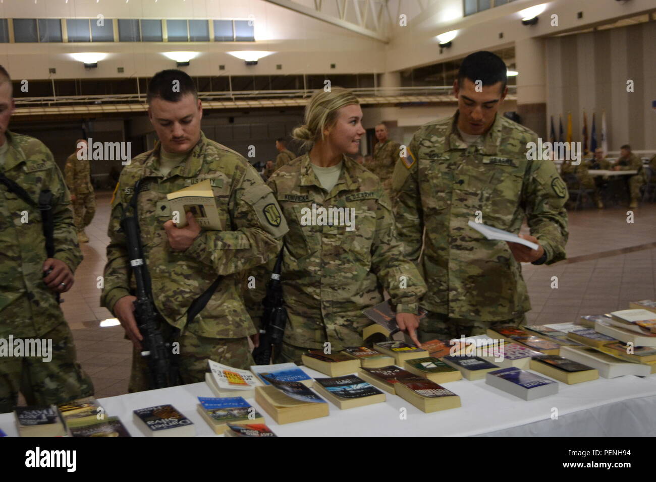 Soldiers assigned to the 116th Engineer Company look over books ...