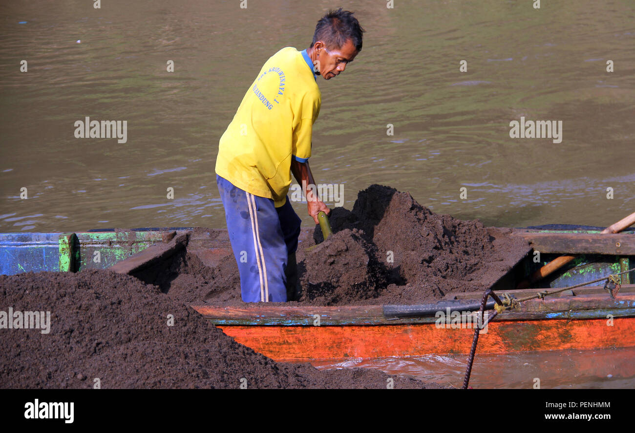 River sand miner working on barge, Citarum River, Bandung, Indonesia ...