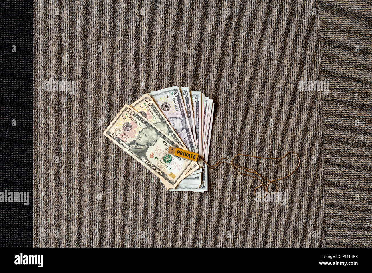 USB flash with private data and cash on a light textured background ...