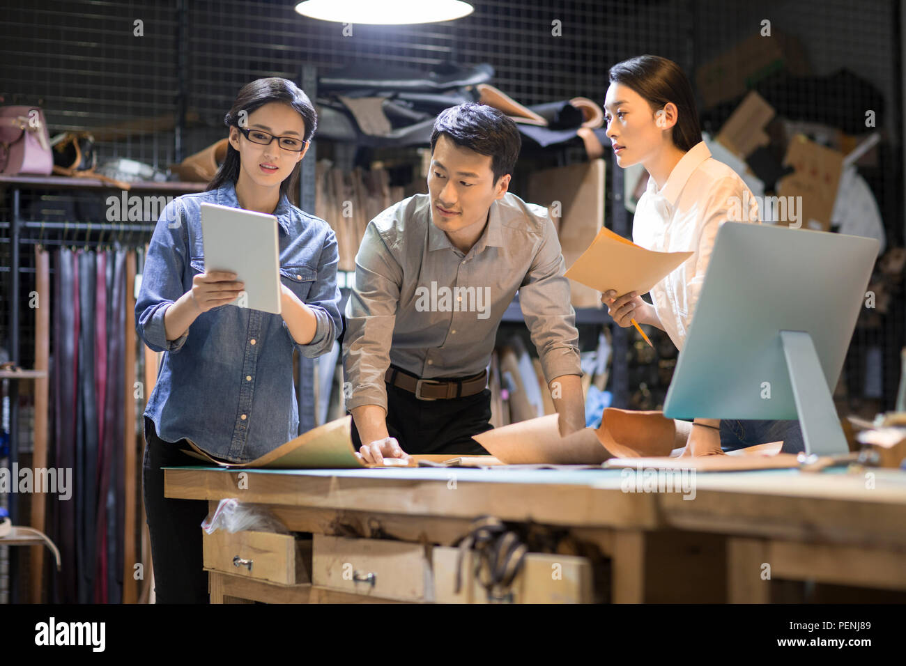 Confident leather craftspeople working in studio Stock Photo - Alamy