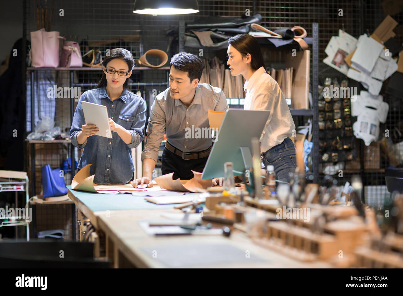 Confident leather craftspeople working in studio Stock Photo - Alamy
