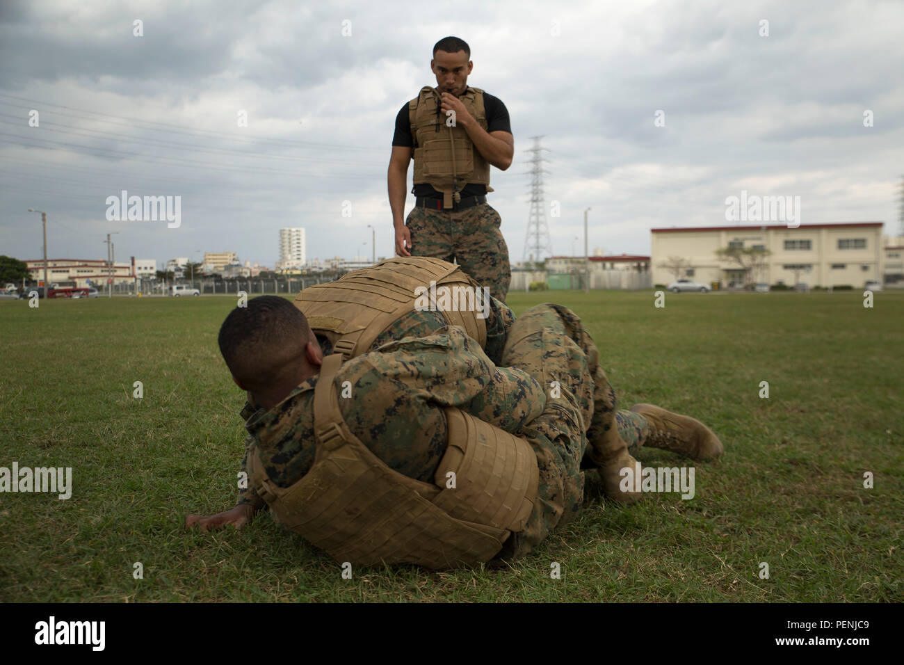 Sgt. Felix Raudales supervises two Marines grappling Dec. 17 aboard ...