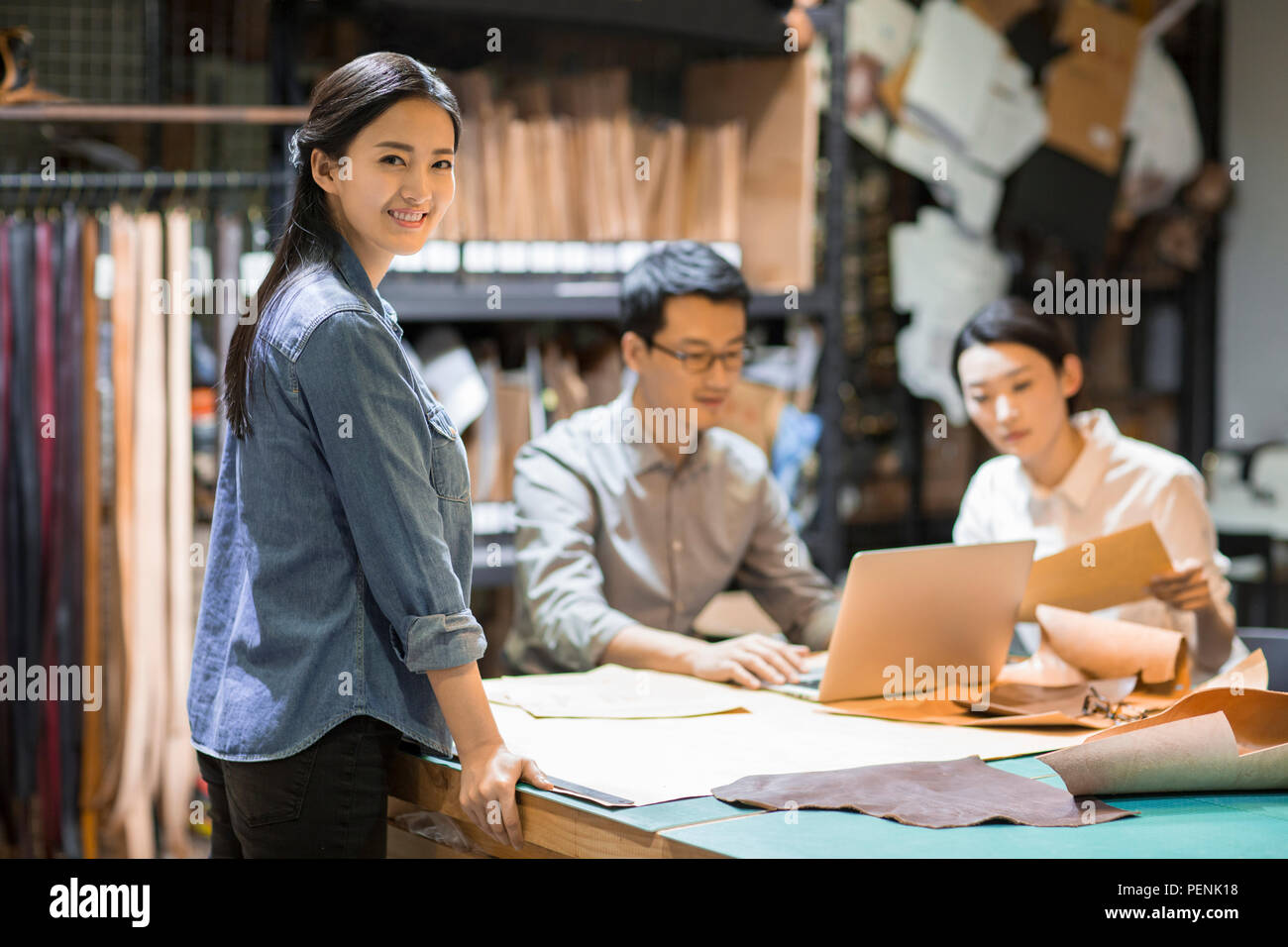 Confident leather craftspeople working in studio Stock Photo - Alamy